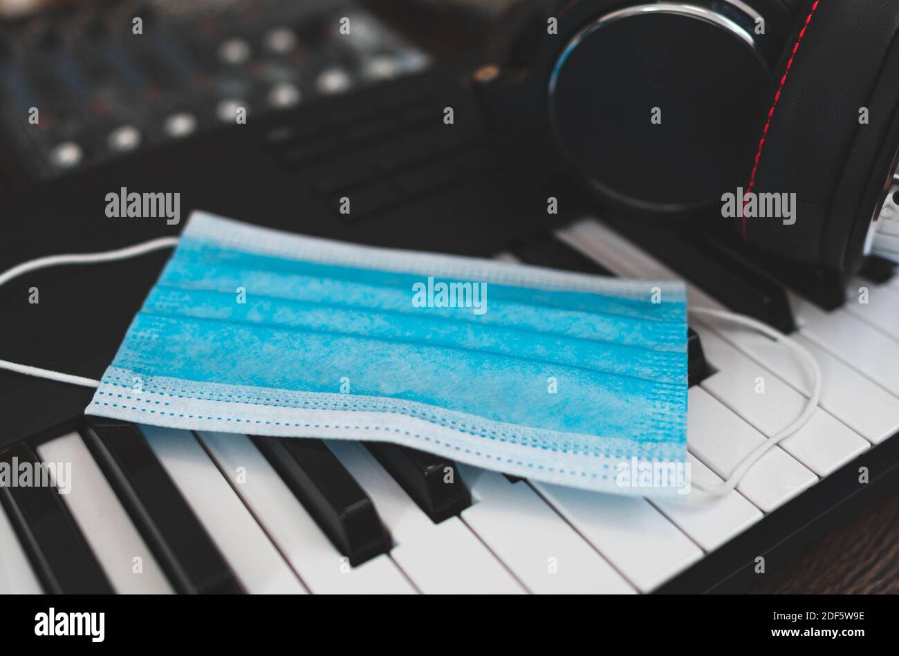 Piano and medical mask in music studio. Covid-19 restrictions concept ...