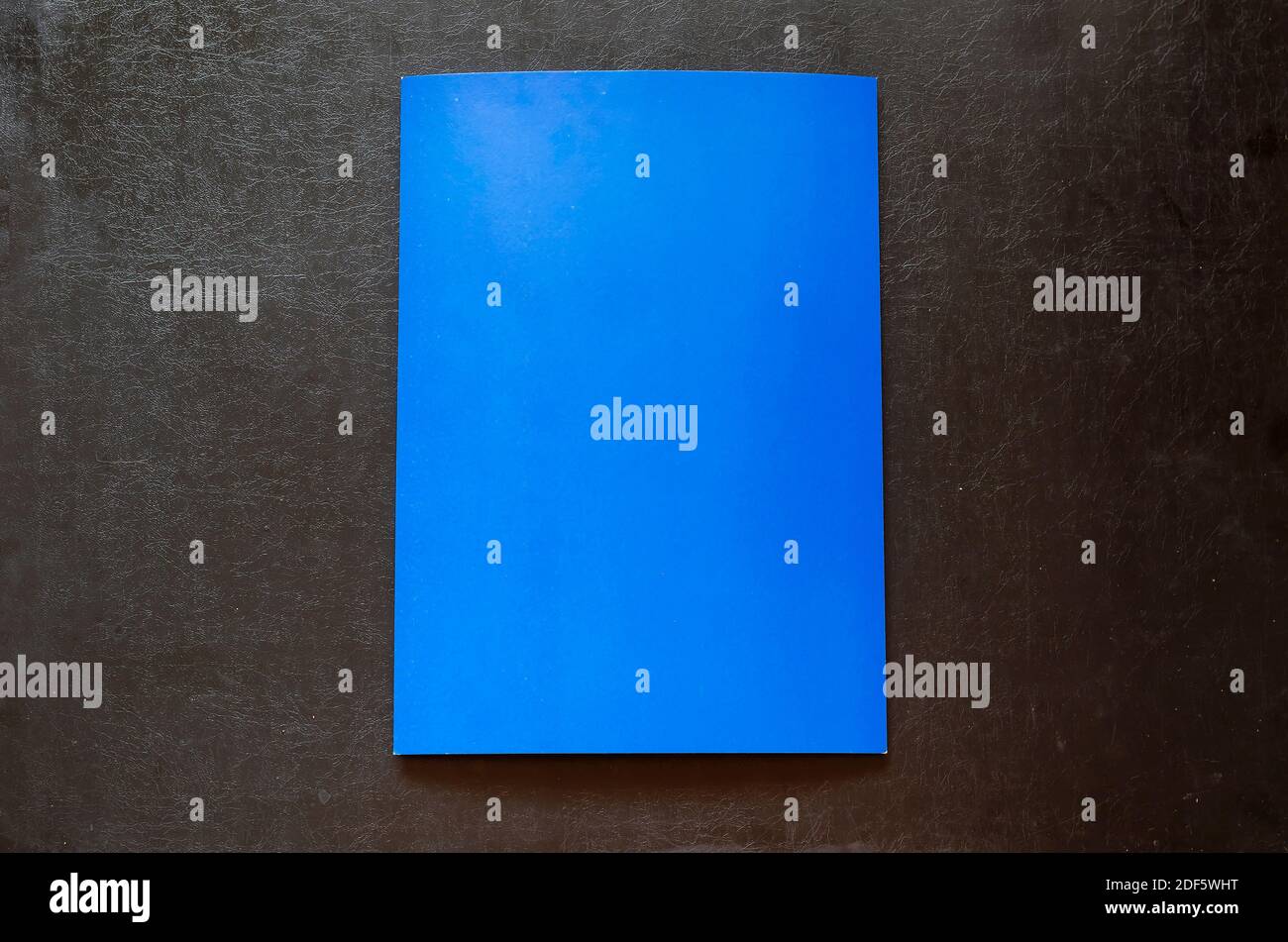 Rectangular sheet of blue paper on a black background. Minimalistic ...