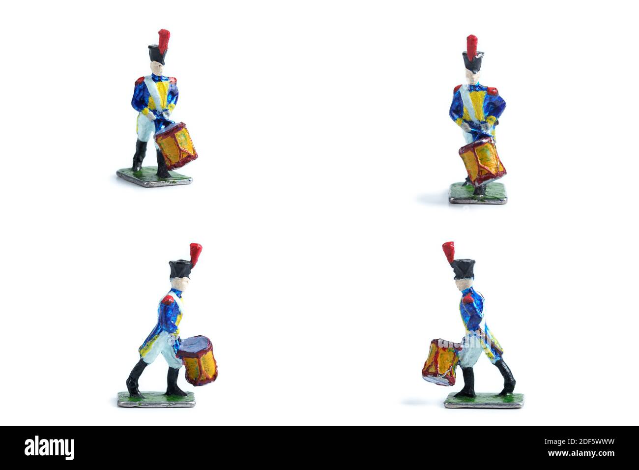 4 in 1 shot of handmade tin soldiers with drum on the white background ...