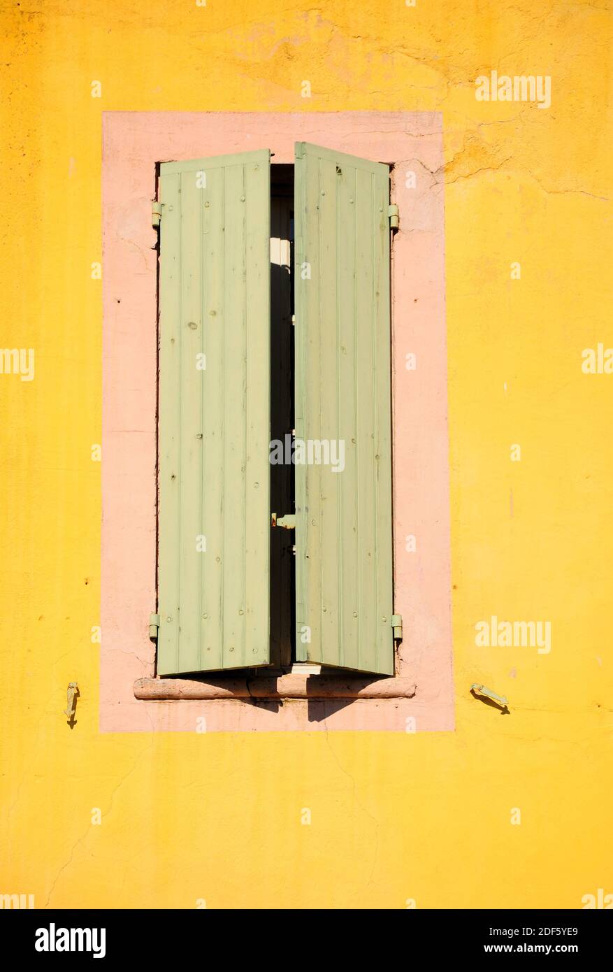 Half closed window of French house shuttered with wooden shutters Stock ...