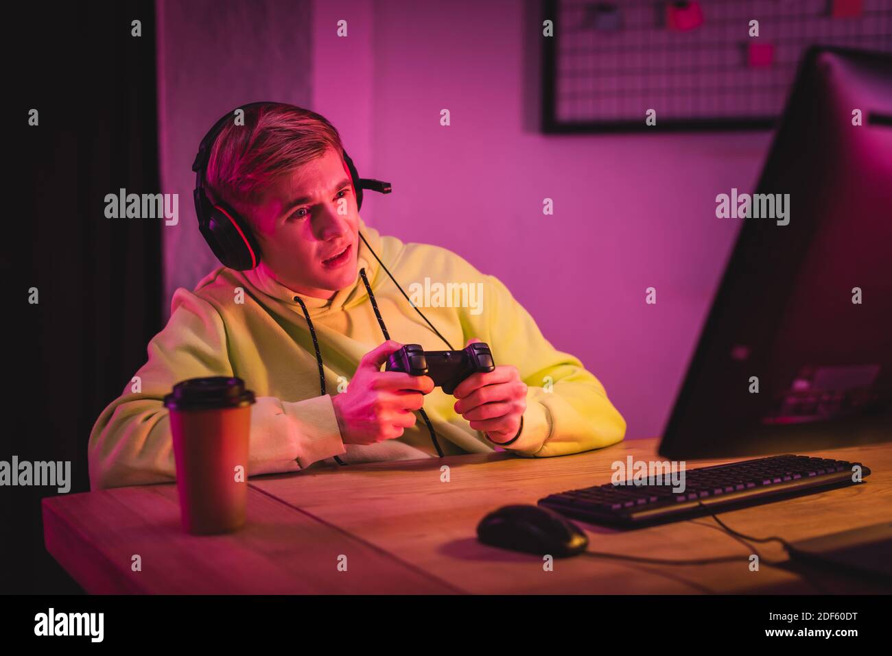 KYIV, UKRAINE - AUGUST 21, 2020: Focused gamer using joystick while ...