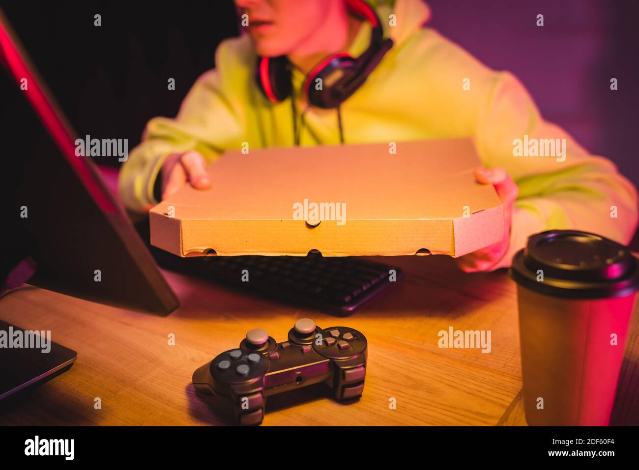 KYIV, UKRAINE - AUGUST 21, 2020: Joystick and coffee to go near gamer ...