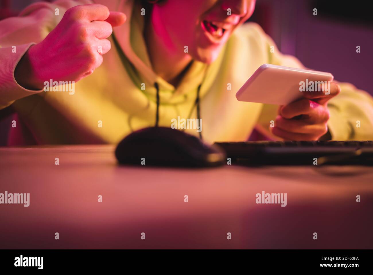 Cheerful gamer showing yes gesture while playing video game on ...