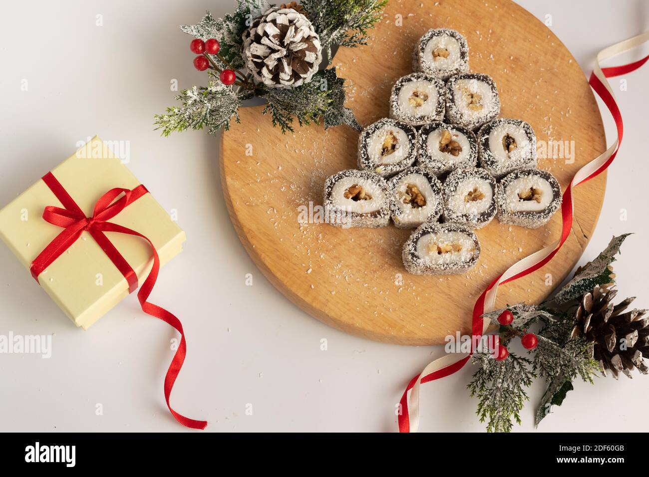 Christmas festive gift box and sweets with seasons decorations on white ...