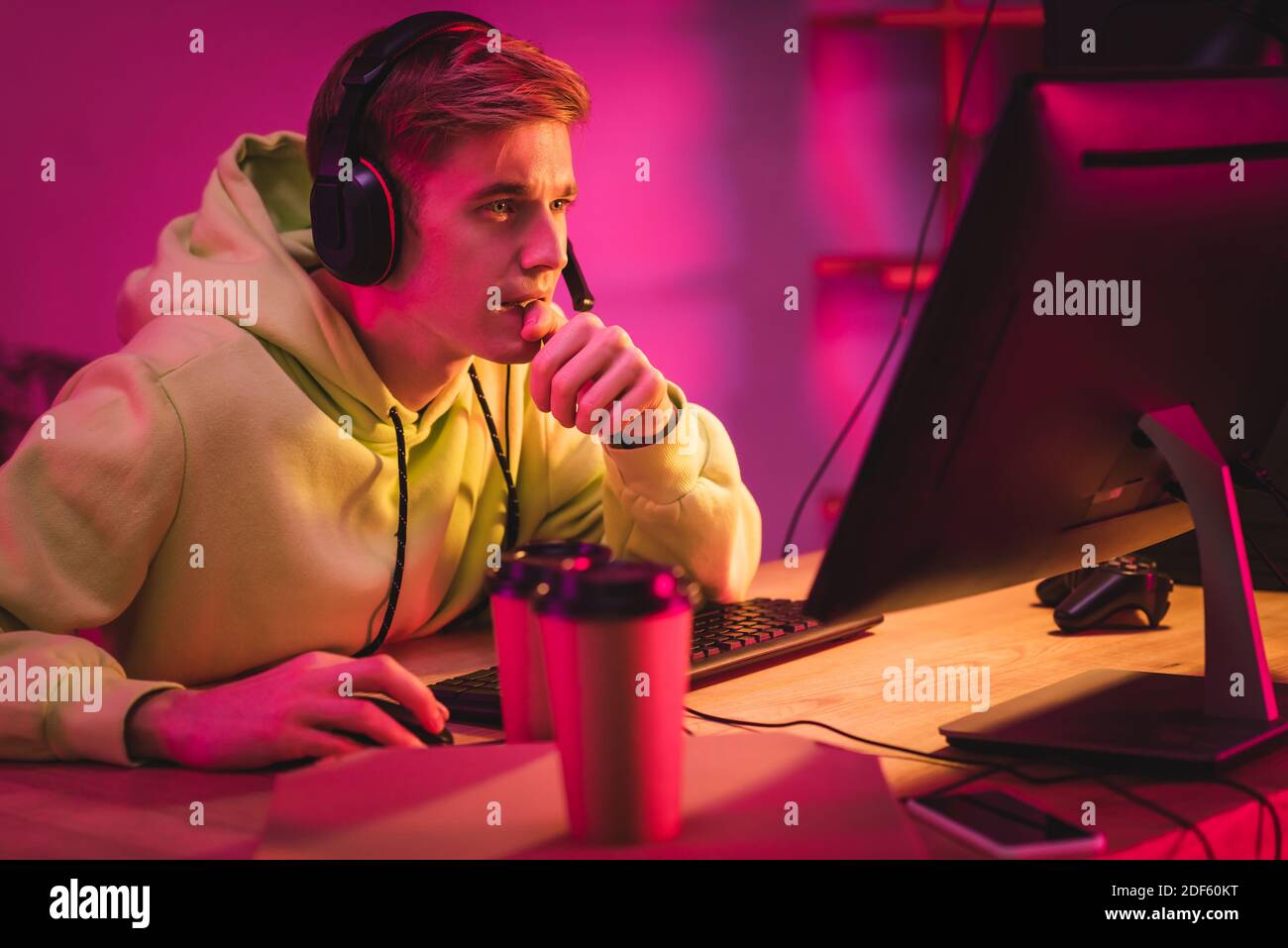 KYIV, UKRAINE - AUGUST 21, 2020: Focused gamer in headset using ...