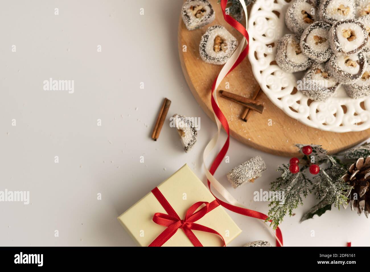 Christmas festive gift box and sweets with seasons decorations on white ...