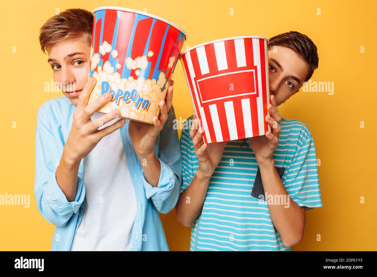 Image of two frightened teenagers, guys watching a horror movie and ...