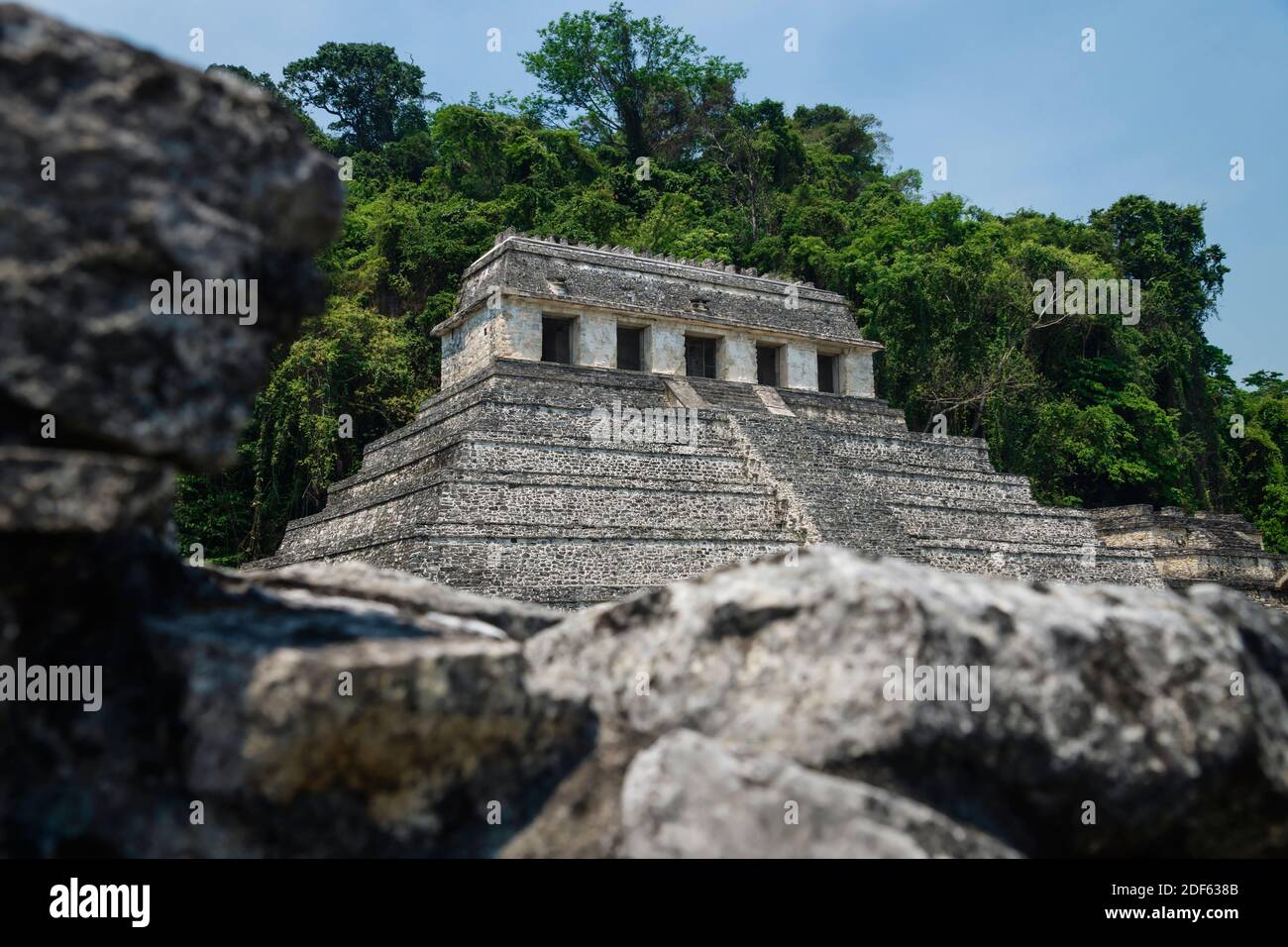 Temple of the inscriptions behind ruin wall at the archaeological Mayan ...