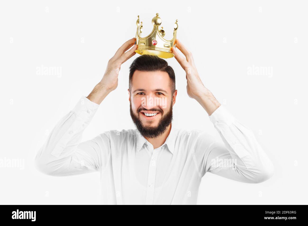 A man on a white background, wears a crown on his head Stock Photo - Alamy