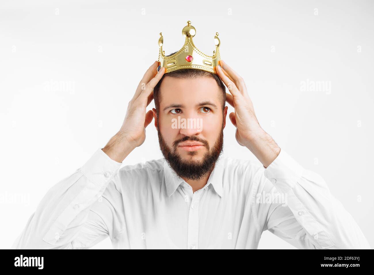 A man on a white background, wears a crown on his head Stock Photo - Alamy