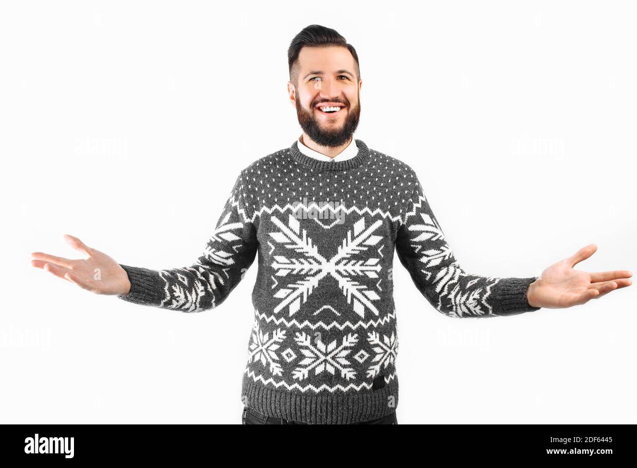 Welcome. Handsome young man with a beard, gestures and smiles, standing ...