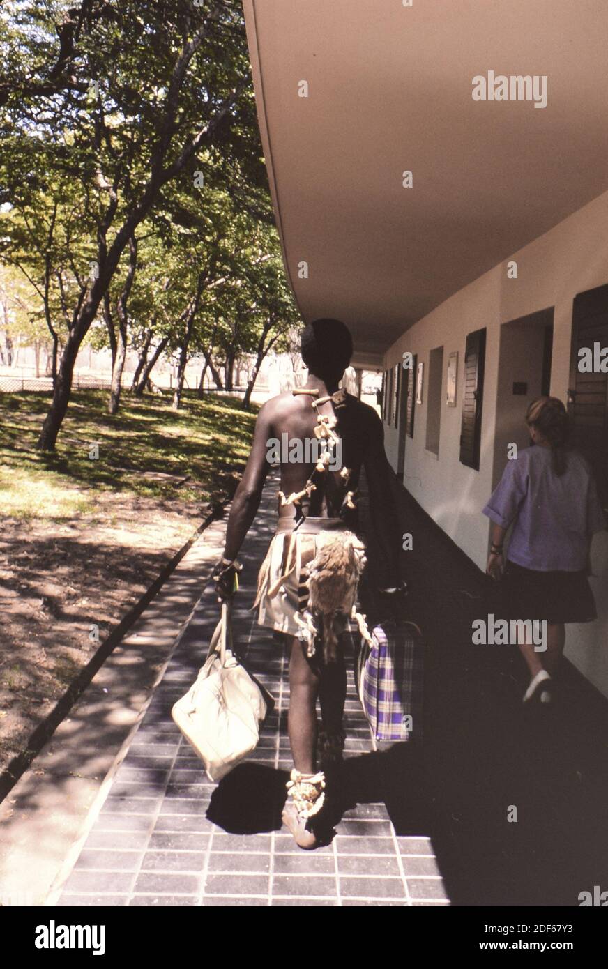 1990s Zimbabwe - Porter at Hwange Lodge, dressed in traditional tribal ...