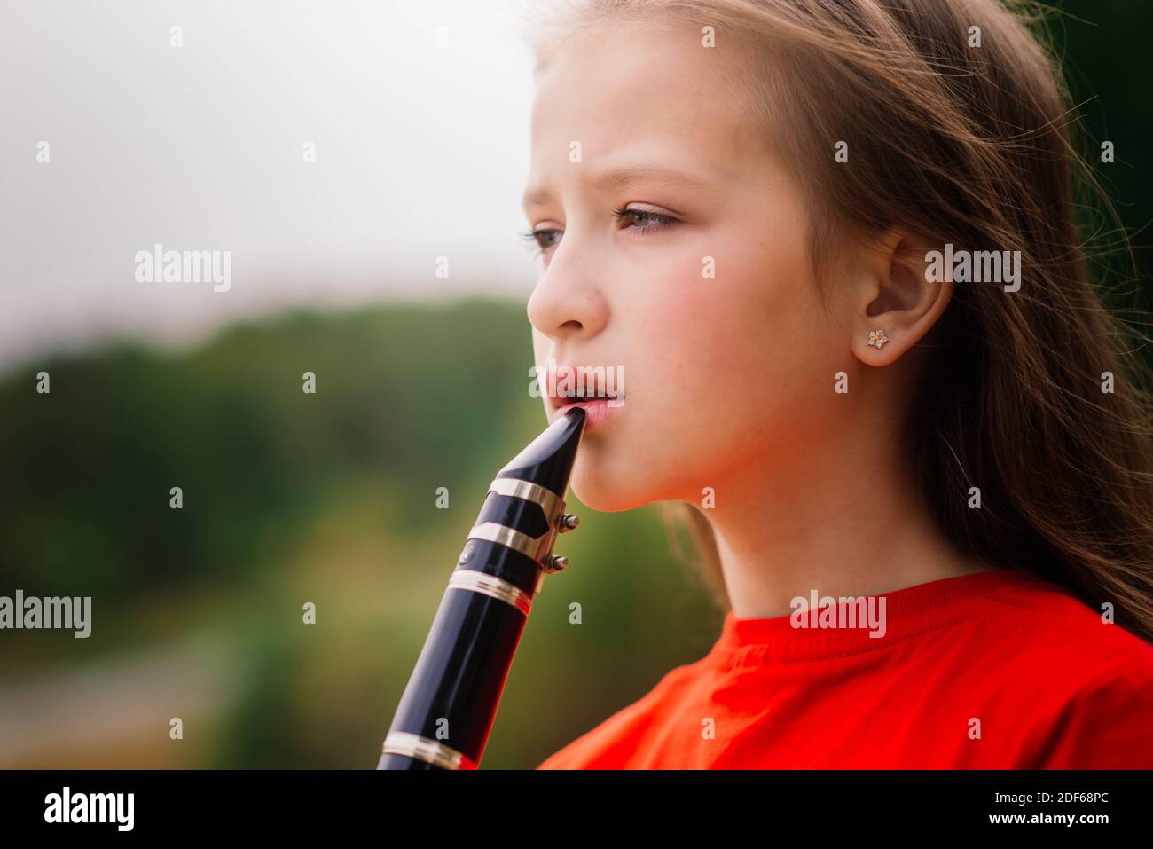 Young attractive girl playing clarinet in fall park Stock Photo - Alamy