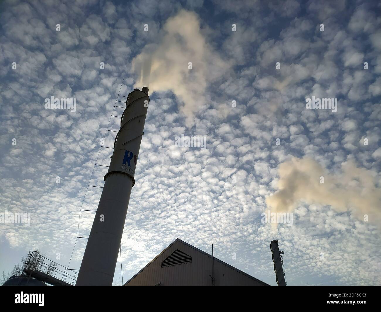 Smoking chimneys of a boiler room in a Riga microdistrict. Emissions of ...