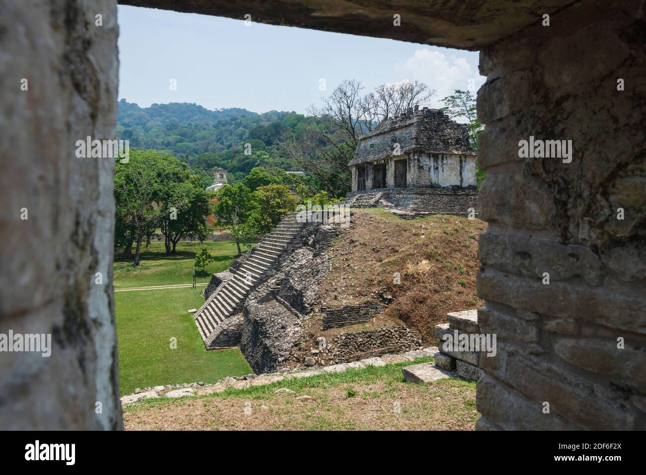 View through gate to small pyramid Mayan ruin temple at the ...