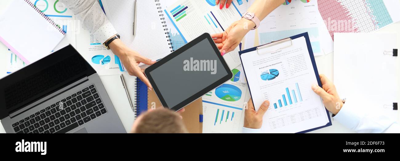 Business people stand around table on which commercial graphics tablet ...