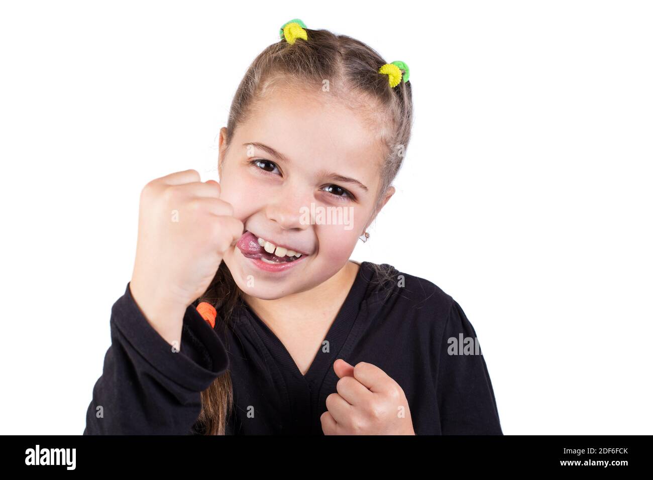 Funny and angry little girl showing tounge ant fists, isolated on a ...