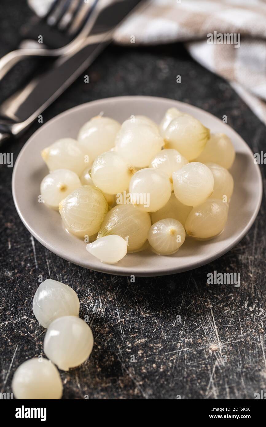 Pickled mini baby onions on plate Stock Photo - Alamy