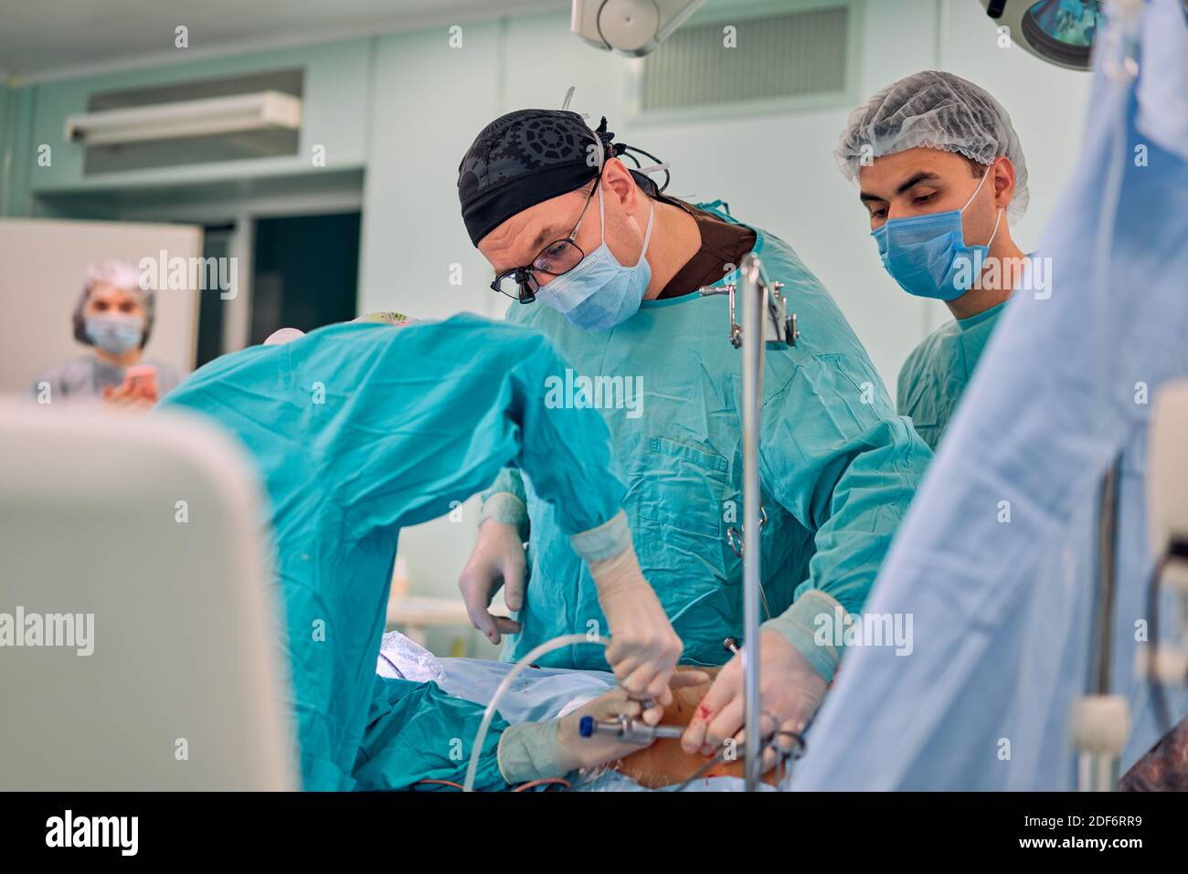 Surgeon Inserting Tube Into Patient During Surgery Stock Photo - Alamy