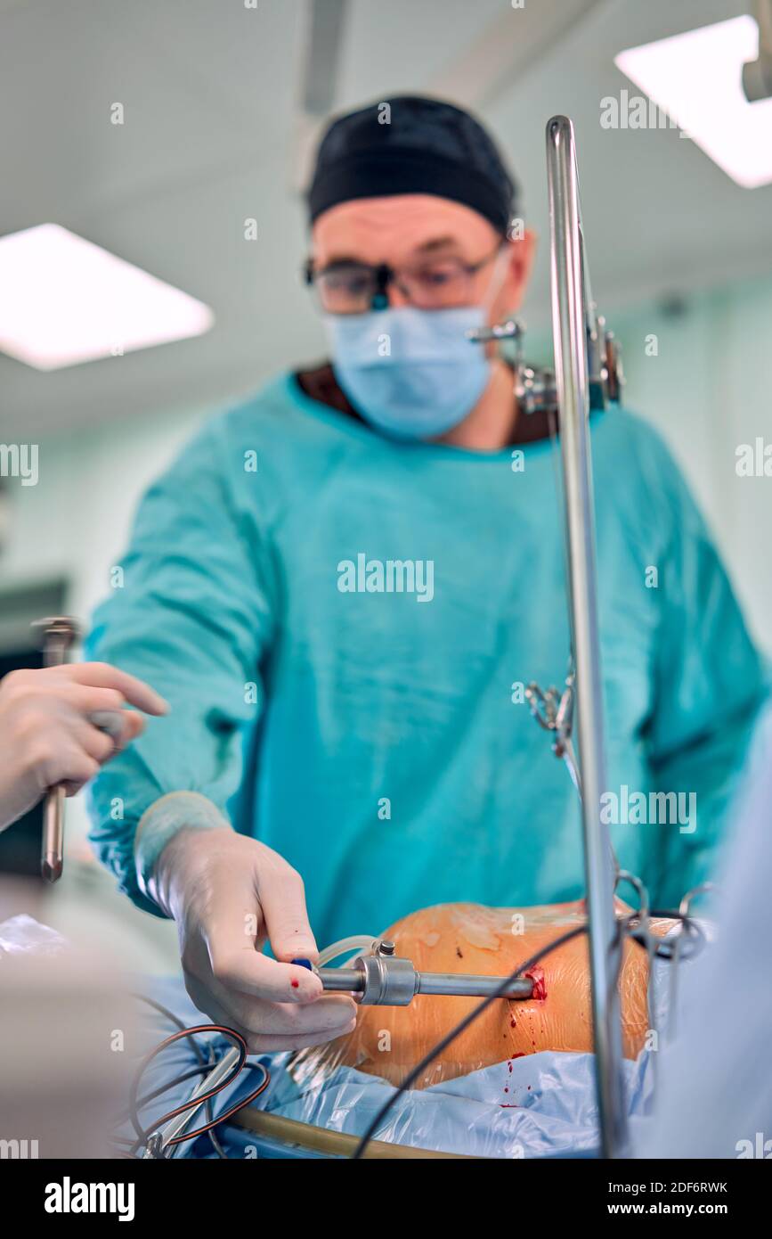 Surgeon Inserting Tube Into Patient During Surgery Stock Photo - Alamy