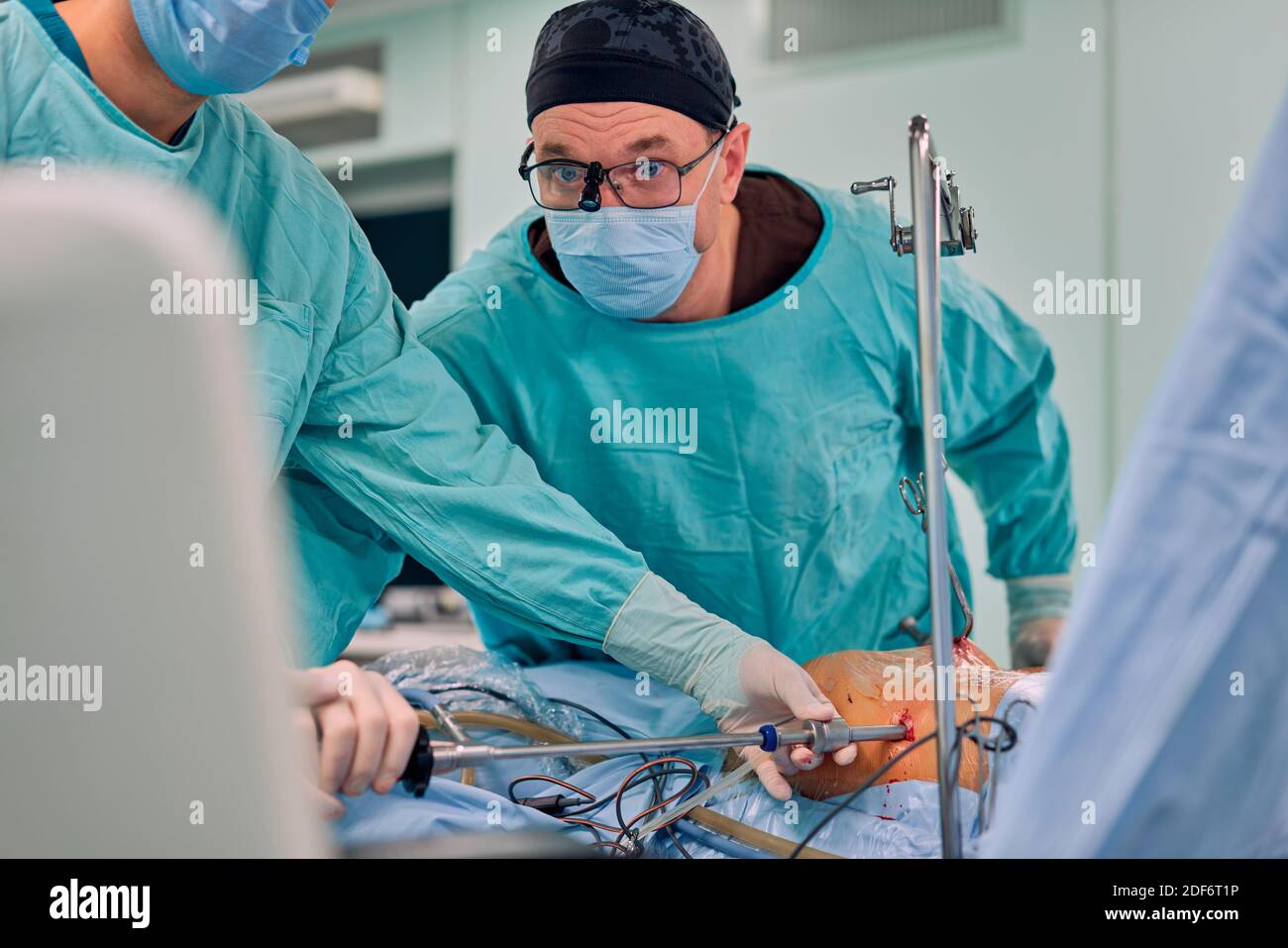 Surgeon Inserting Tube Into Patient During Surgery Stock Photo - Alamy
