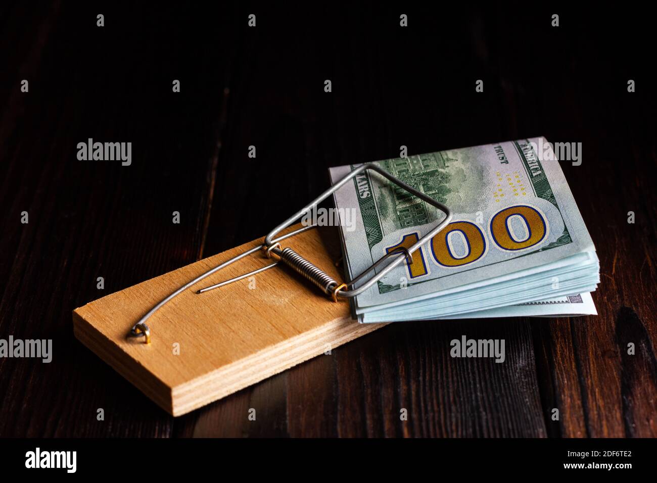 A bundle of one hundred dollar bills in a mousetrap. Financial trap ...