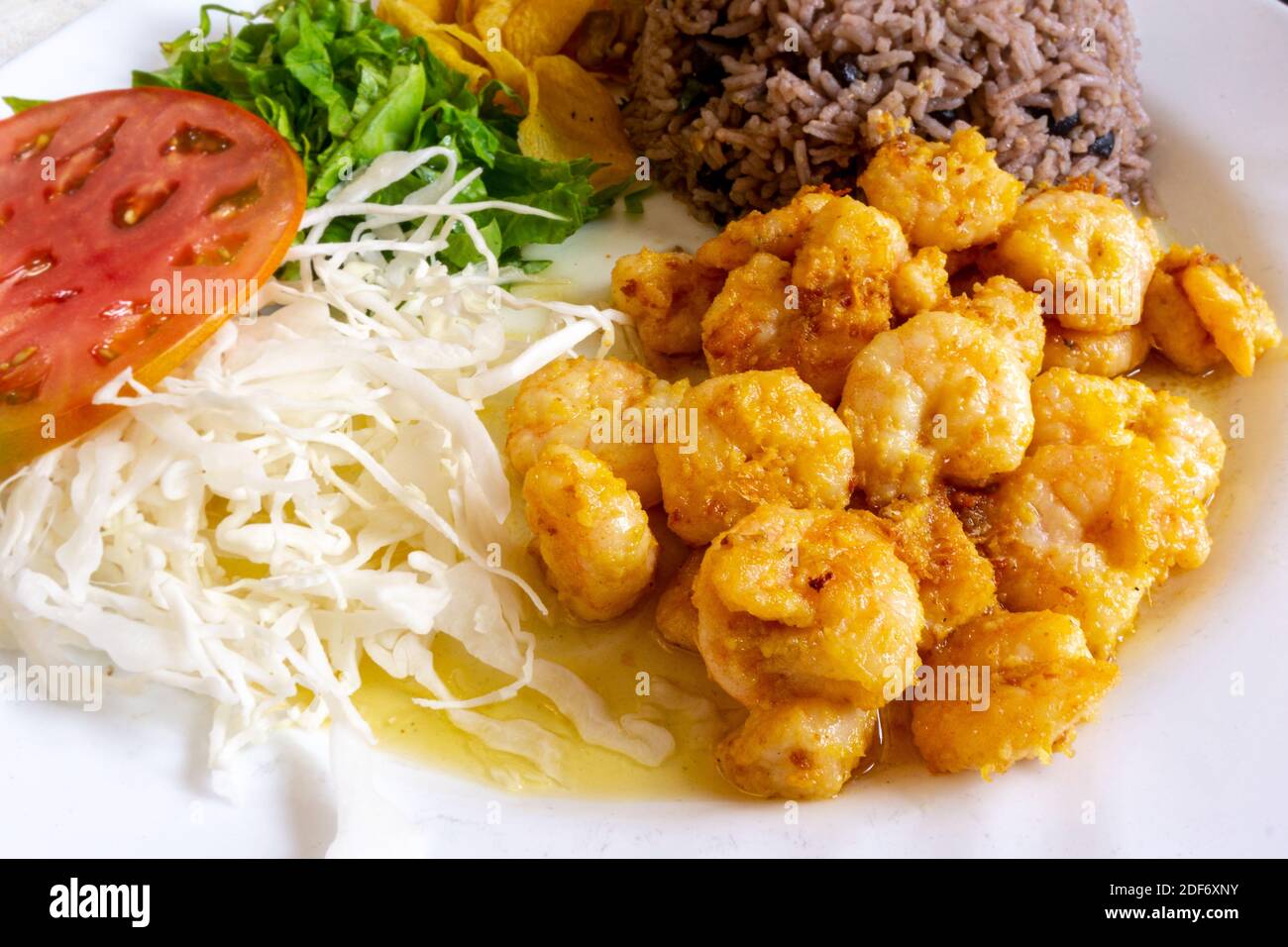 Cuban cuisine, cooked shrimp with congri rice and salad Stock Photo - Alamy