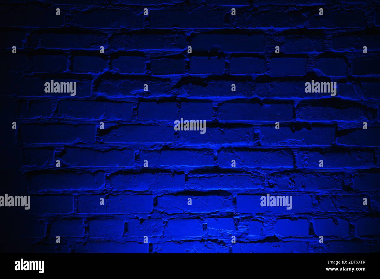 Empty brick wall with dark blue neon light background Stock Photo - Alamy