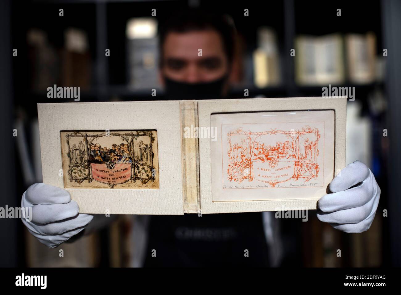 A gallery assistant holds the first printing of the first commercial ...