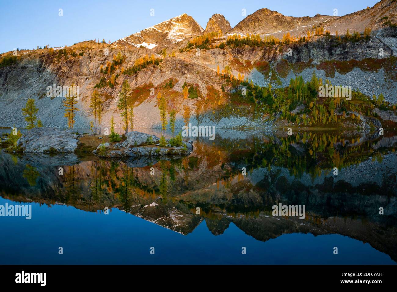 WA18641-00...WASHINGTON - Sun on Mount Maude reflecting on the still ...