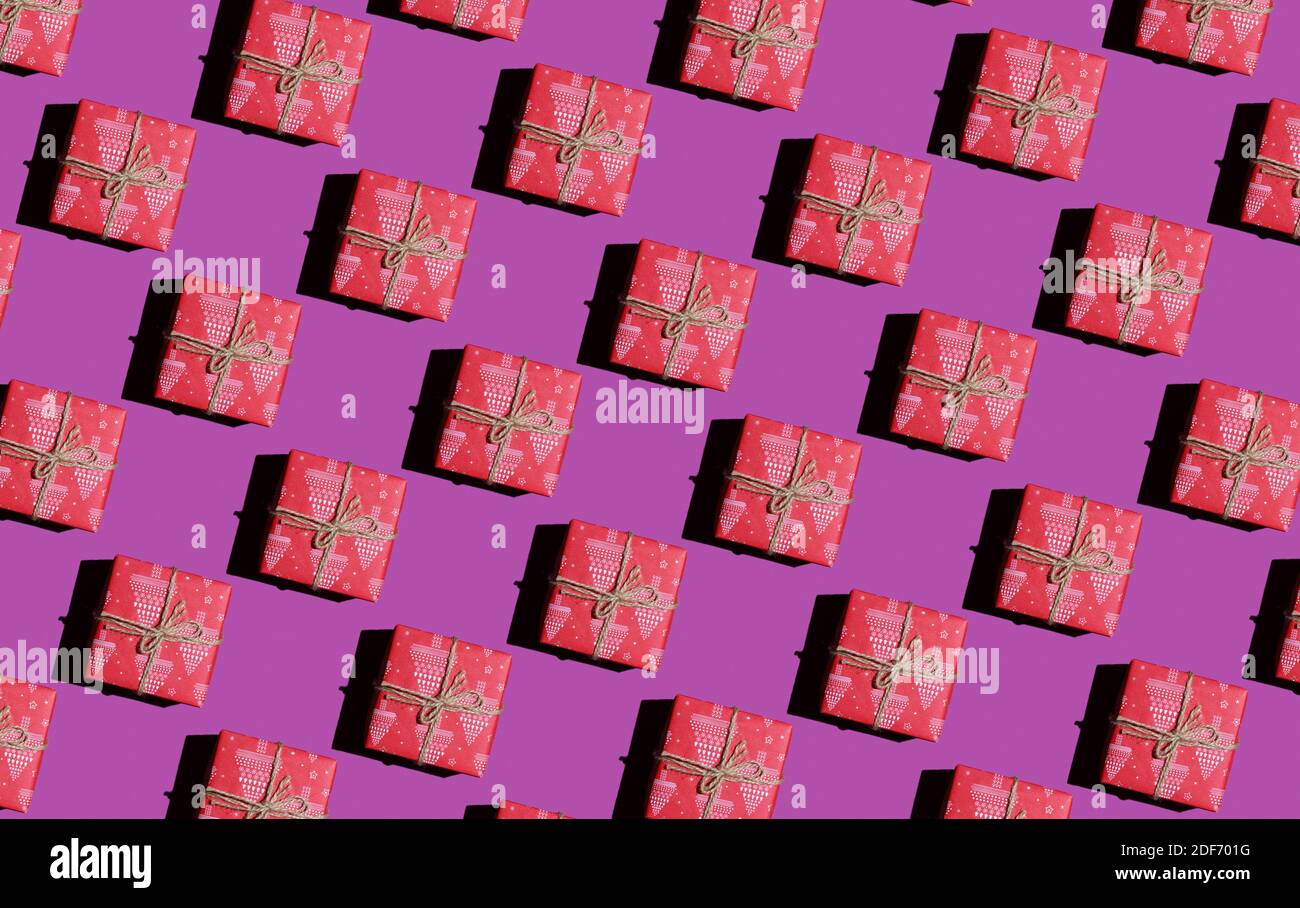 New Year's gift in a red wrapper on a purple background. New year ...