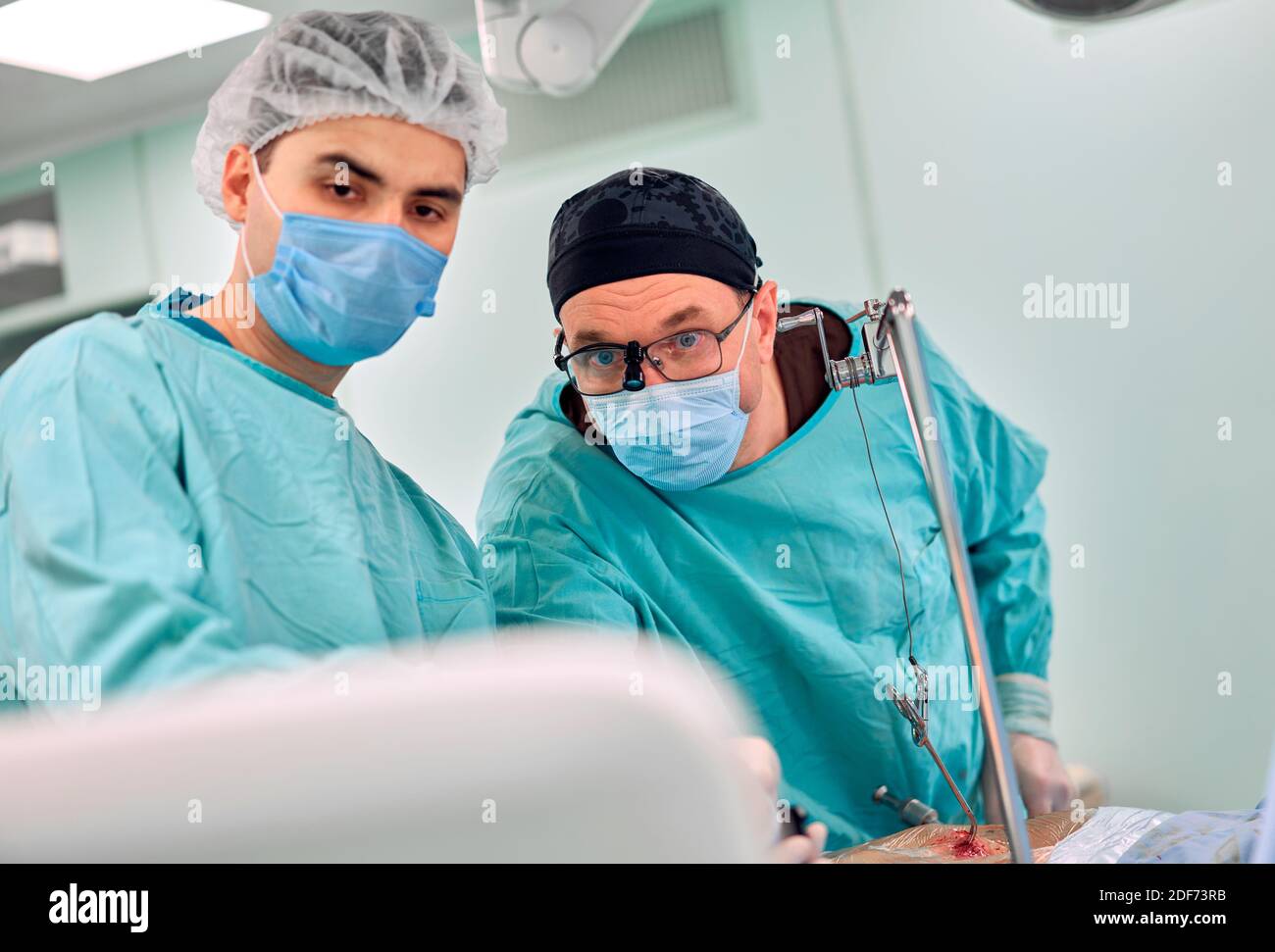 Surgeon Inserting Tube Into Patient During Surgery Stock Photo - Alamy