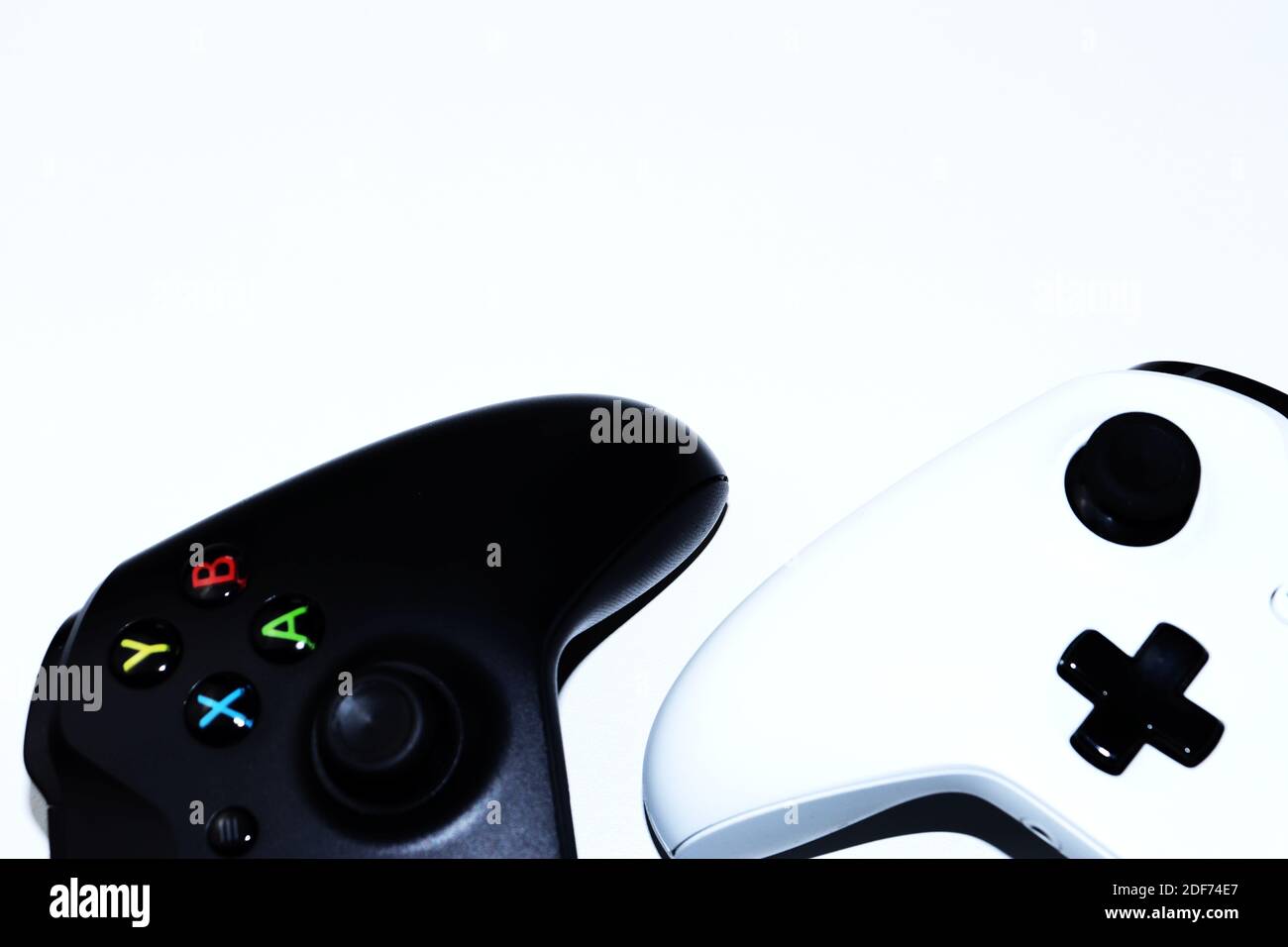 White and black game controller on a white background - console ...