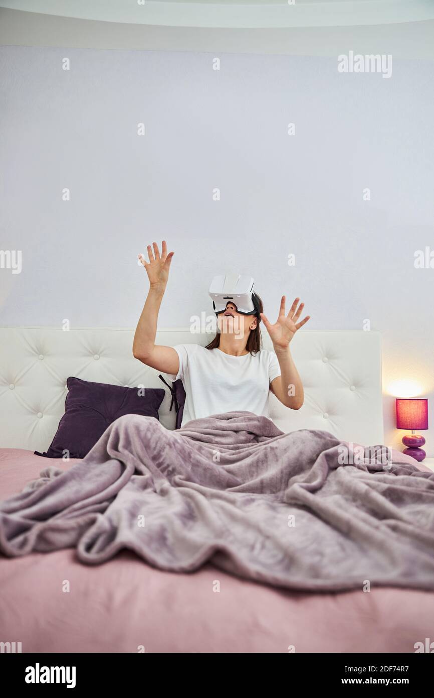 Person in augmented reality headset touching a virtual object Stock ...