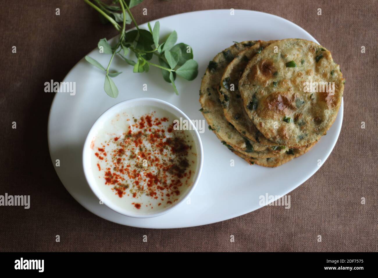 A healthy Indian flatbread called Methi poori made of whole wheat flour ...