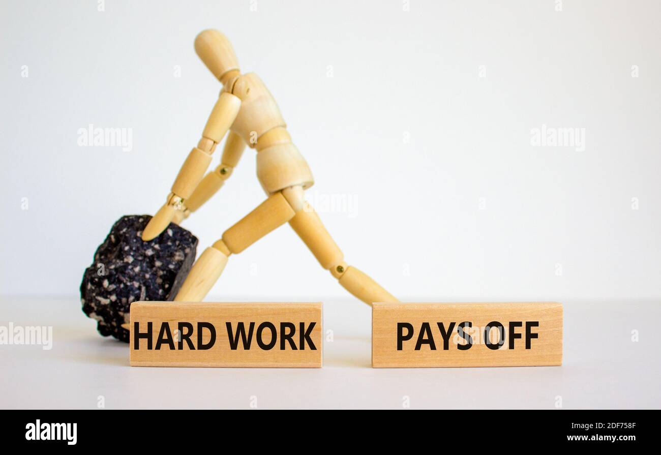 Hard work symbol. Wooden blocks with words 'hard work pays off'. Wooden ...
