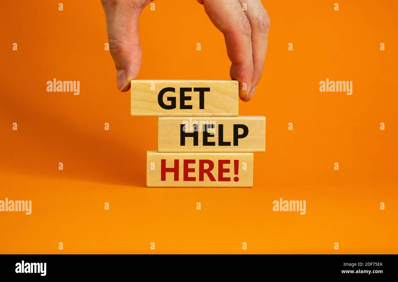 Get help here symbol. Male hand builds stack from blocks with words ...