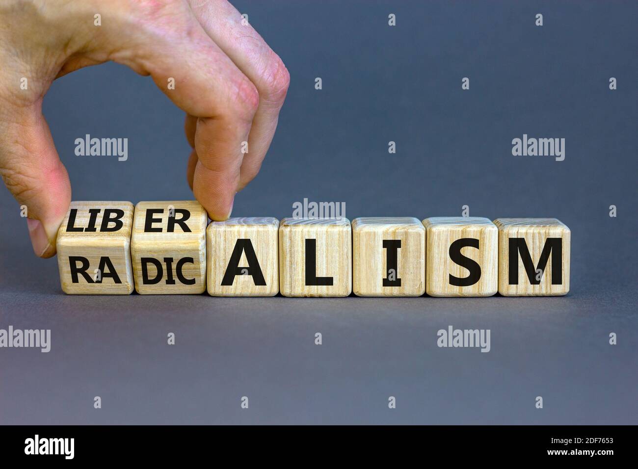 Radicalism or liberalism symbol. Male hand turns cubes and changes the ...