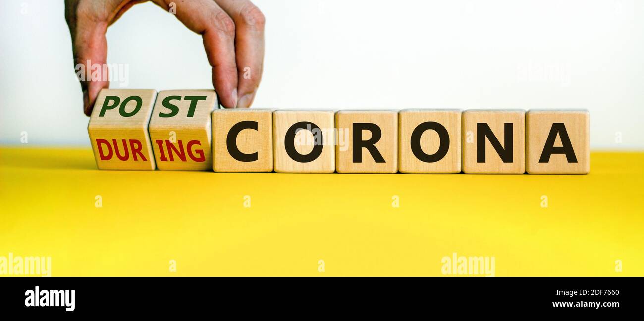 Symbol for a post-corona time. Male hand turns cubes and changes the ...