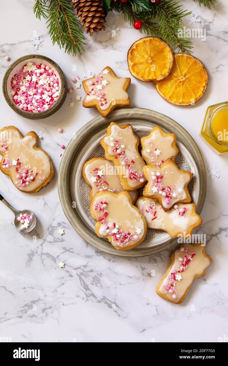 Christmas baking. Homemade gingerbread cookies with glaze on a marble ...