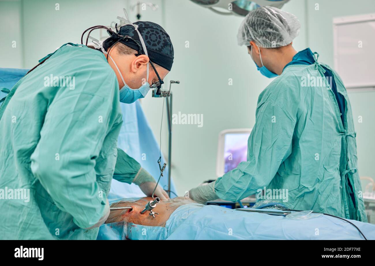 Surgeon Inserting Tube Into Patient During Surgery Stock Photo - Alamy