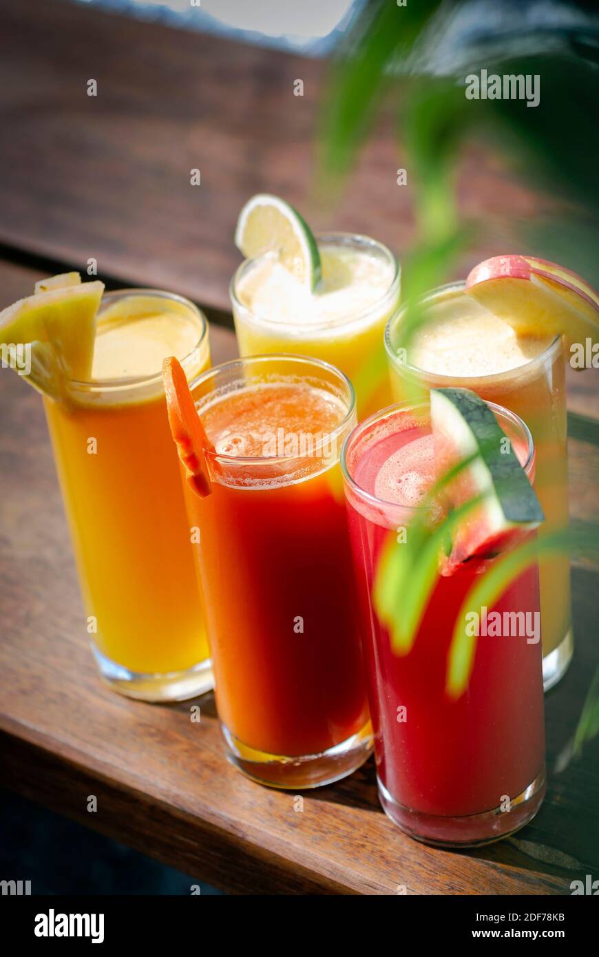 mixed fresh organic fruit juice glasses selection on sunny garden table Stock Photo - Alamy