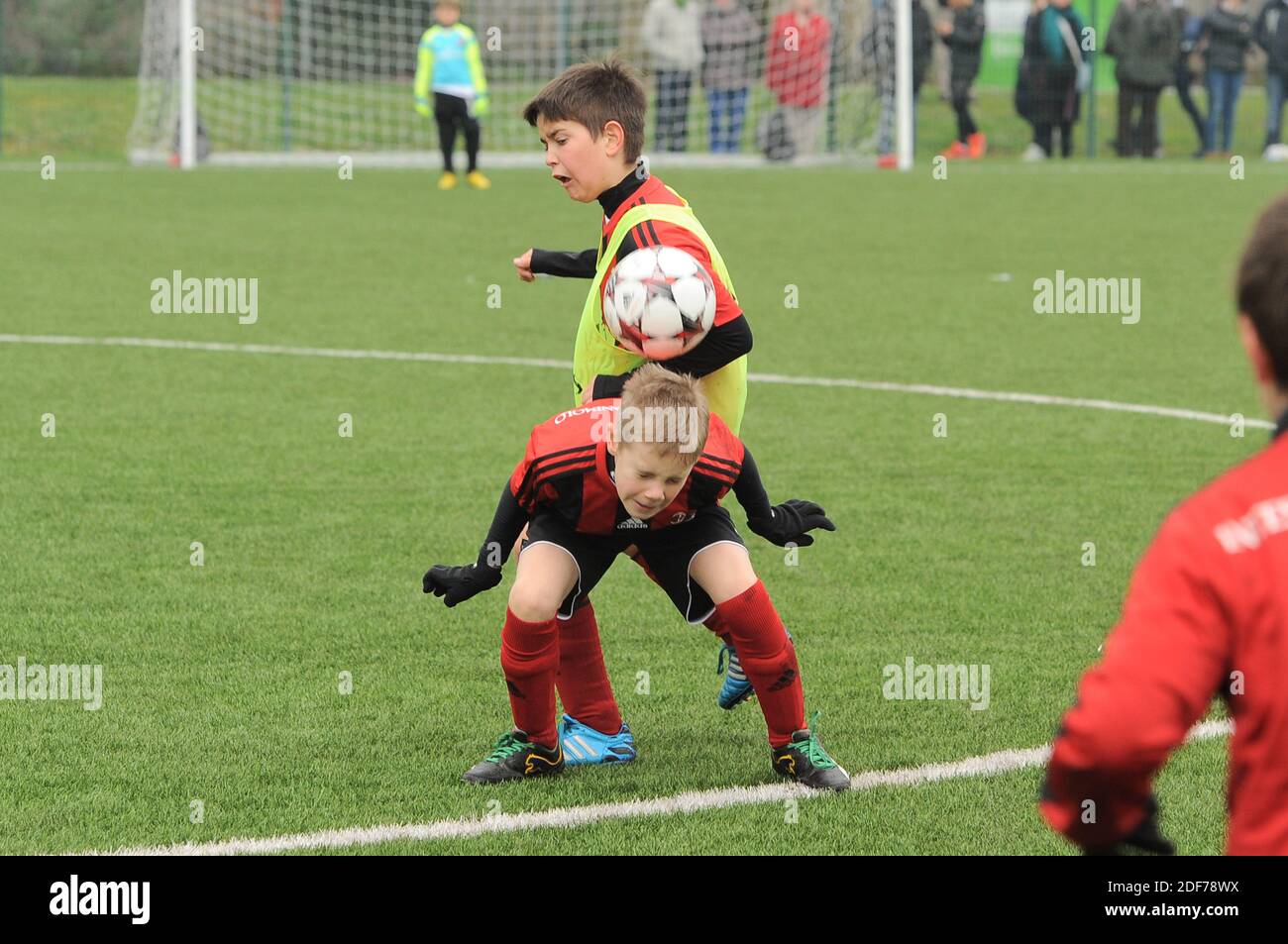 Kids' soccer, children play ball in football school Stock Photo - Alamy