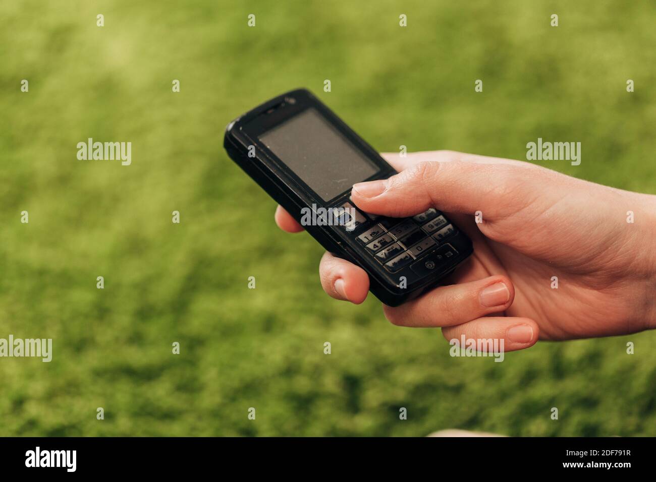 Girl Holds An Old Button Phone In Her Hand Stock Photo - Alamy