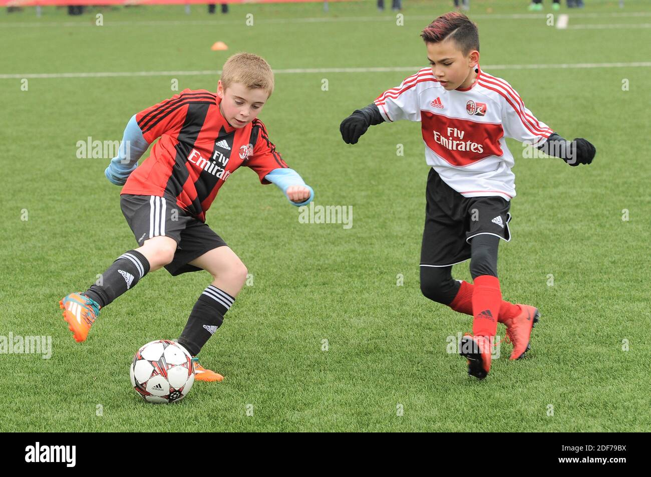 Kids' soccer, children play ball in football school Stock Photo - Alamy