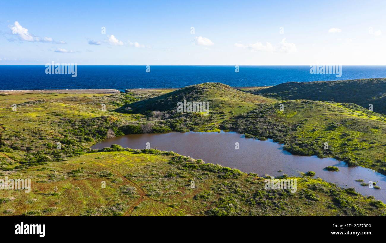 Aerial scenery over hills and lake above Caribbean Island of Curacao ...