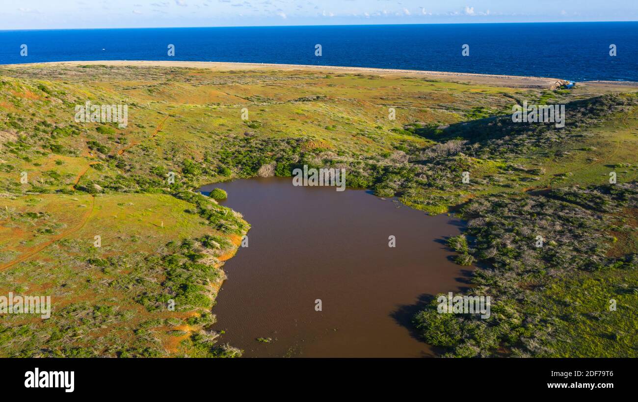 Aerial scenery over hills and lake above Caribbean Island of Curacao ...
