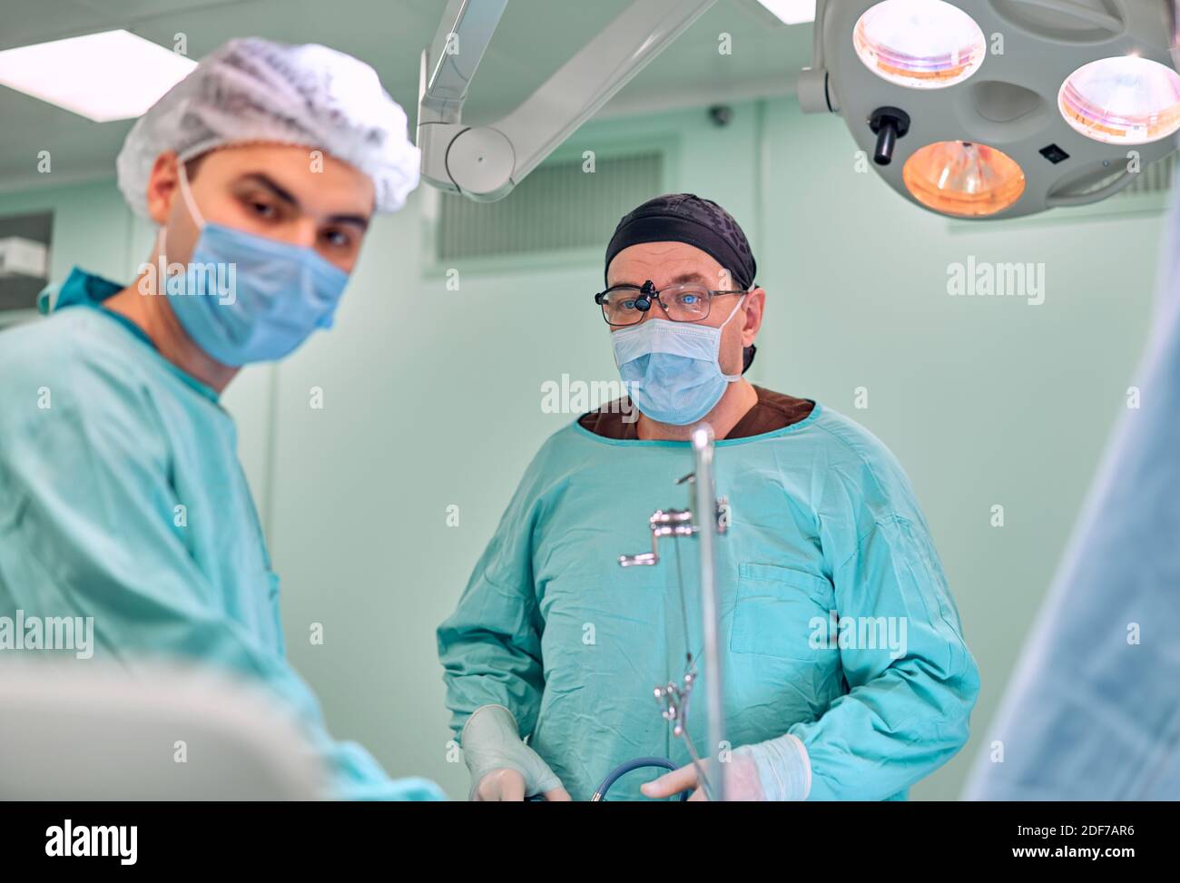 Surgeon Inserting Tube Into Patient During Surgery Stock Photo - Alamy