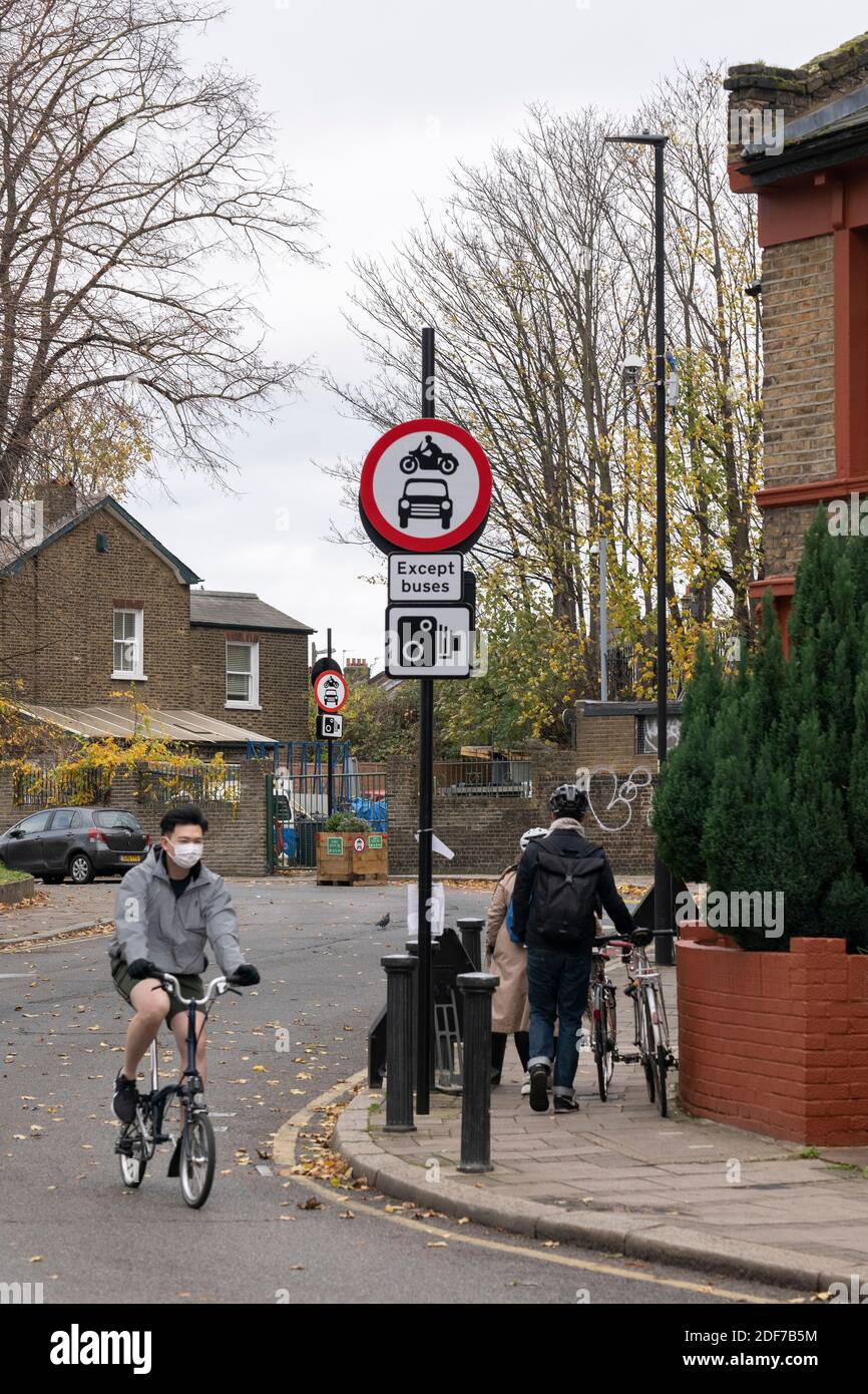 A male cyclist riding a folding bike wearing a face mask on Railton ...