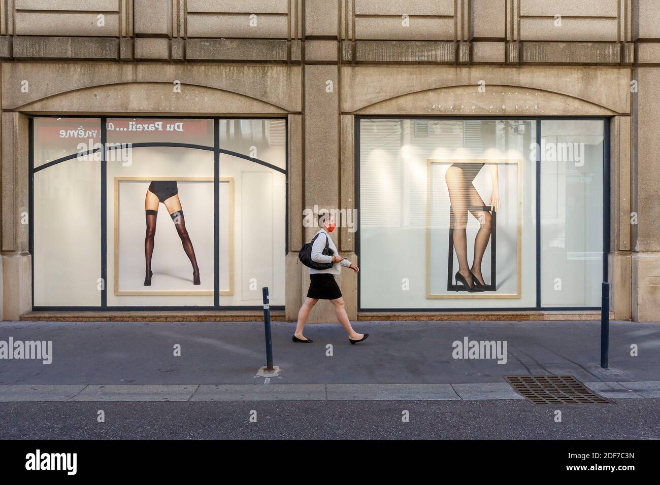 France, Meurthe et Moselle, Nancy, woman walking by the front window of ...
